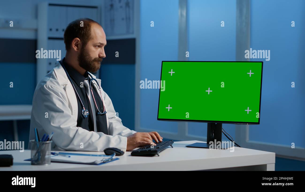 General practitioner typing medical expertise on computer with ...