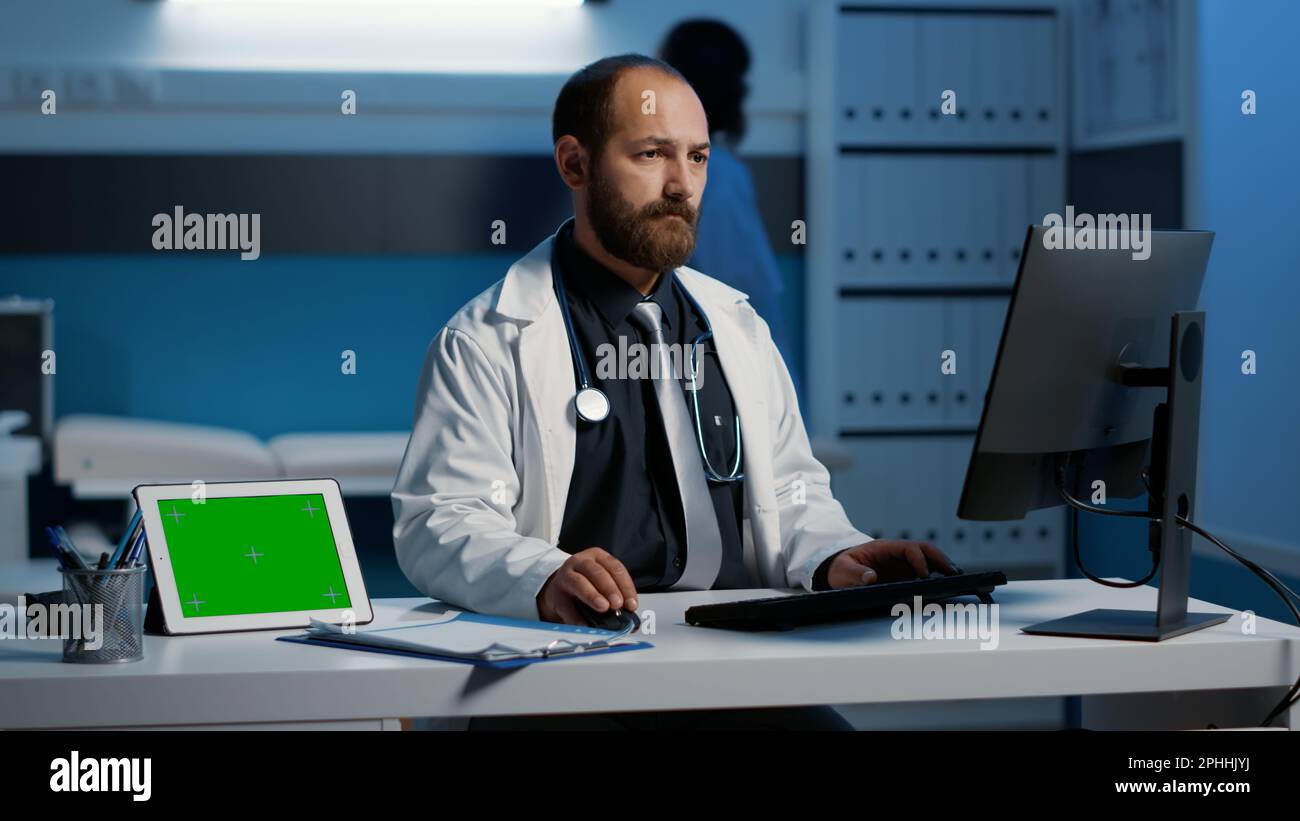 Tablet computer with green screen chroma key display standing on table ...