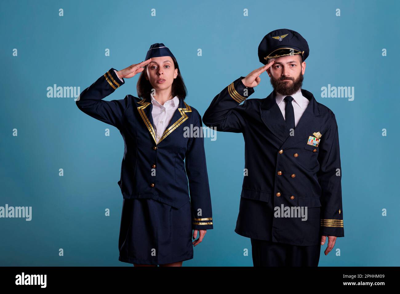 Airplane pilot and flight attendant saluting portrait, airplane crew in ...