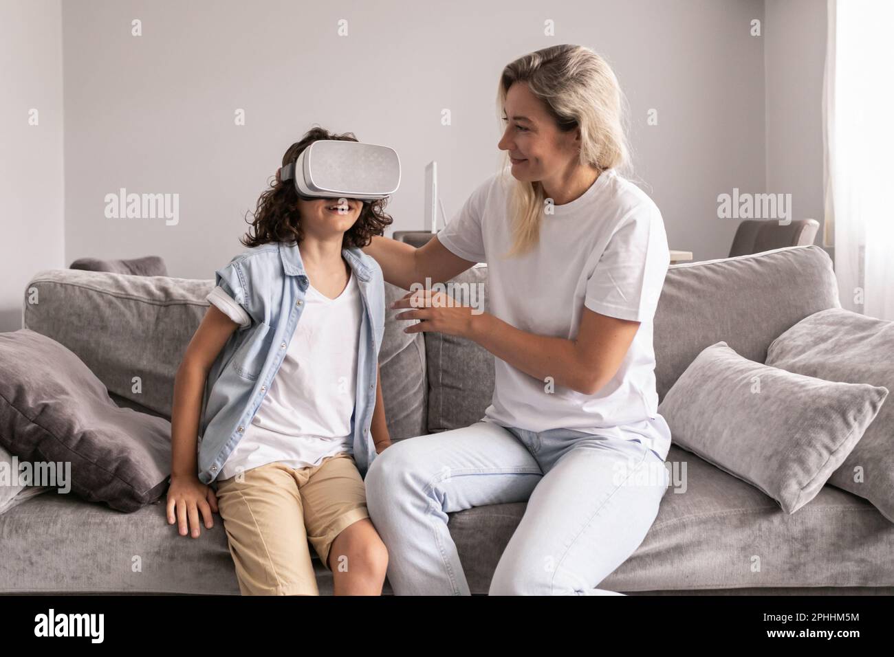 boy kid wearing virtual reality headset with his mother vr glasses in ...