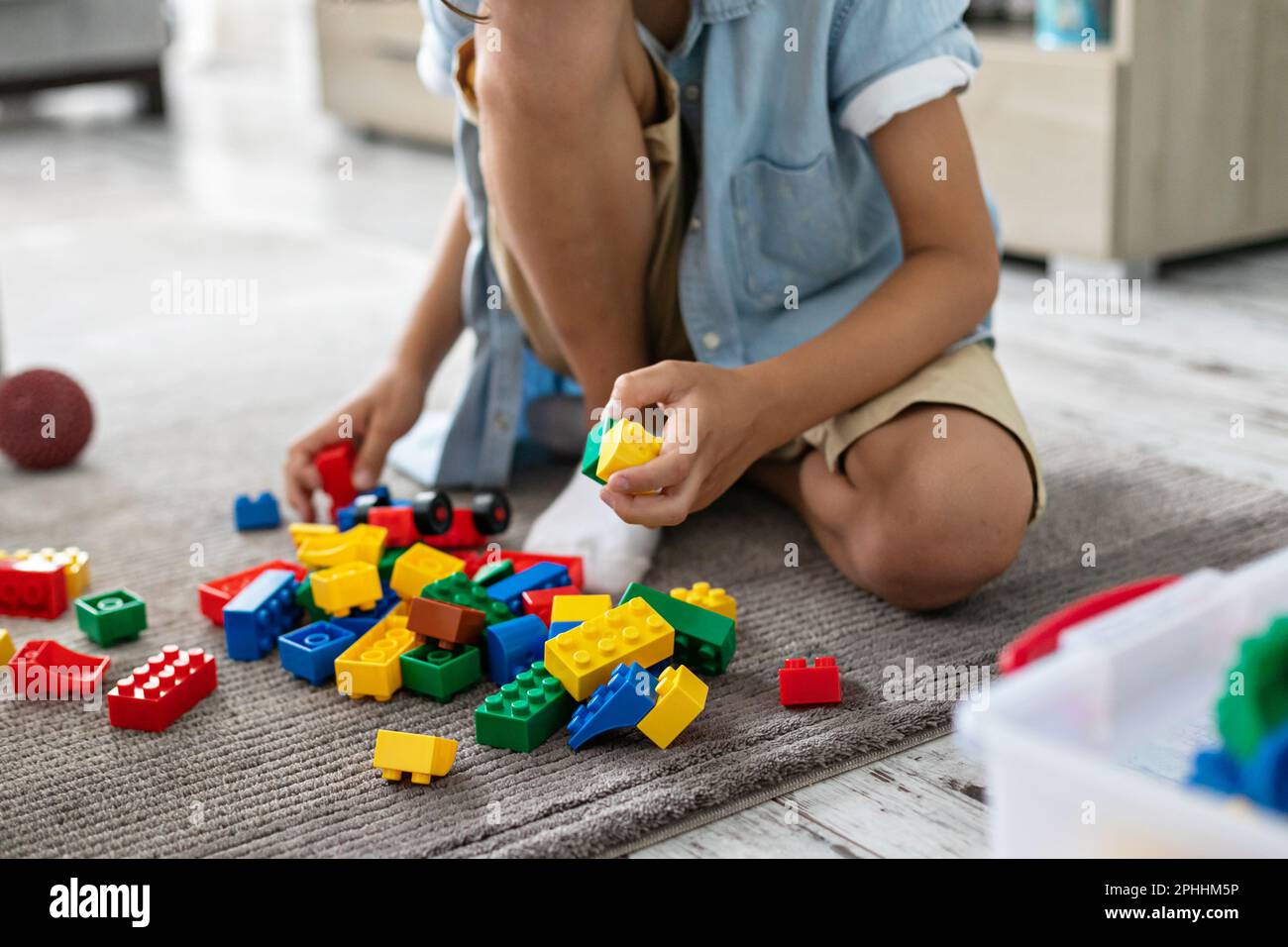 Little toddler boy playing with colorful plastic blocks at home ...
