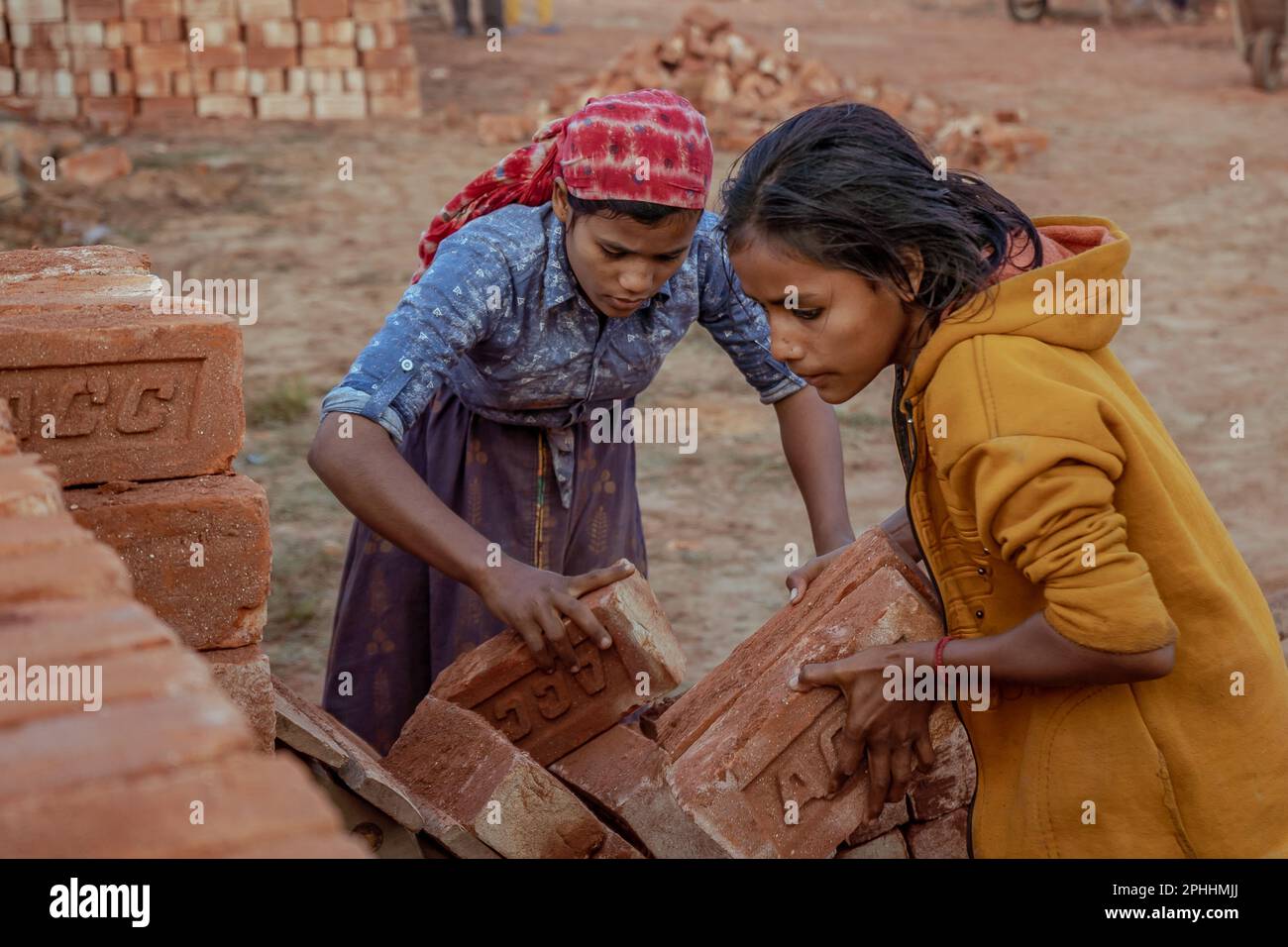 Children organizing bricks for transportation. In recent years, the ...