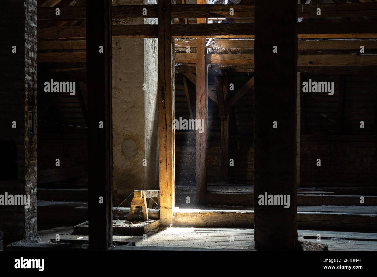 Old and dusty attic illuminated by beam of sunlight making dust ... Old and dusty attic illuminated by beam of sunlight making dust ...