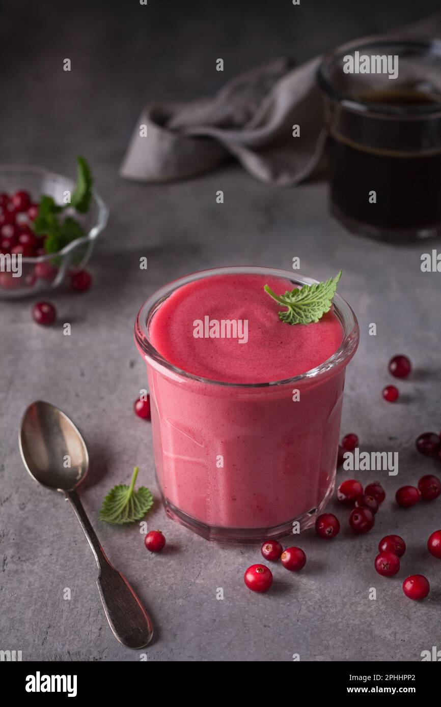 Vegan cranberry mousse with semolina and fresh cranberries on gray ...
