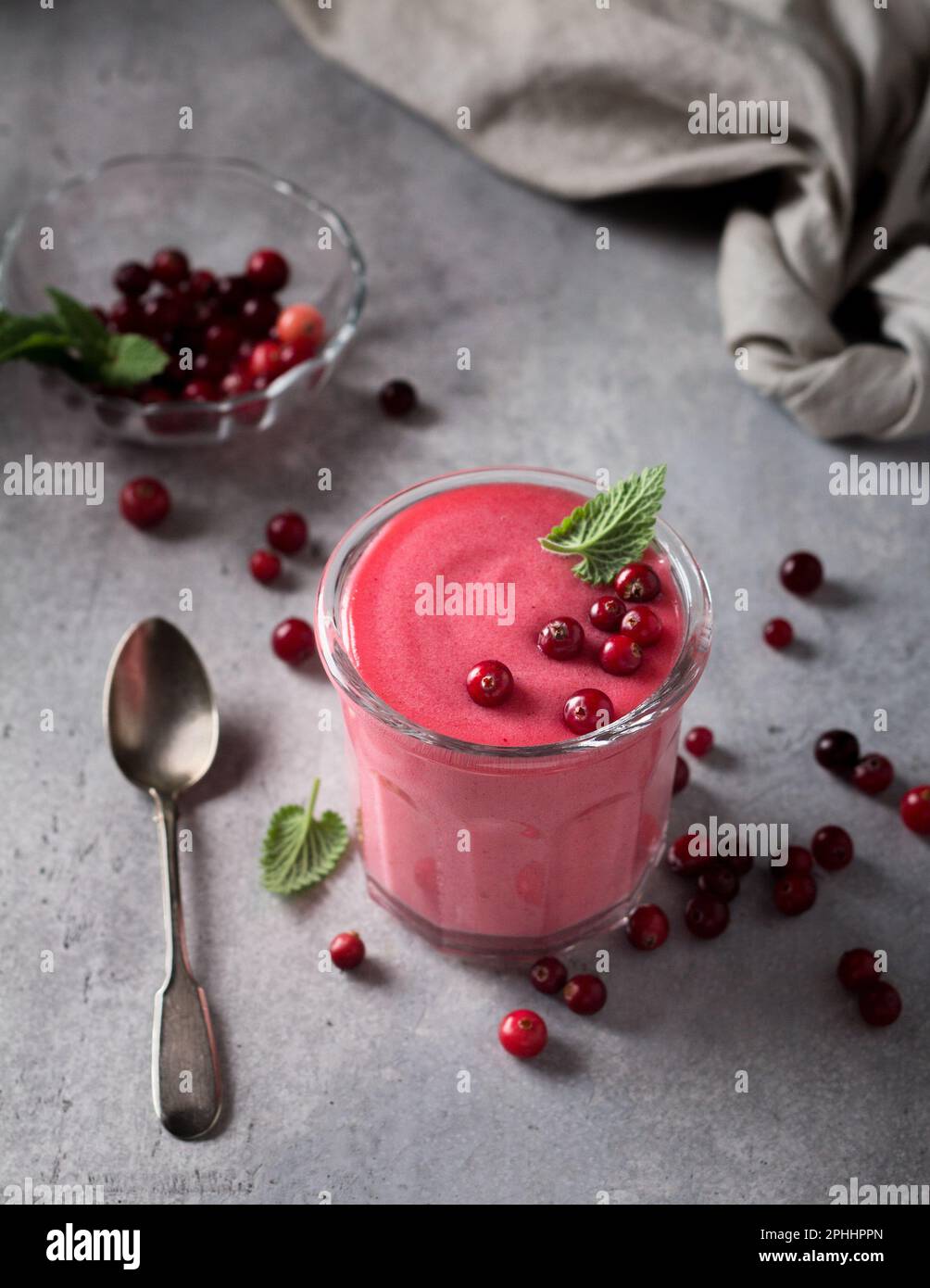 Vegan cranberry mousse with semolina and fresh cranberries on gray ...