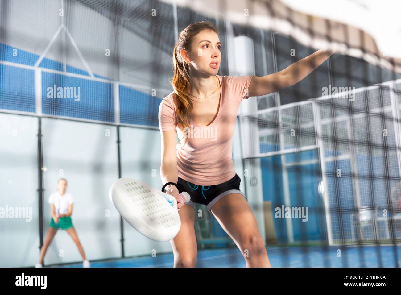 Active sports girl playing padel on tennis court Stock Photo - Alamy