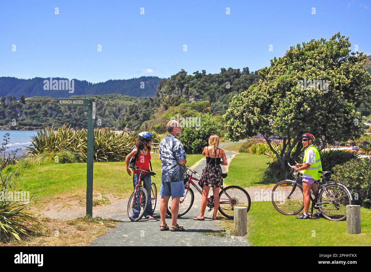 Cyclists and hikers at Pohara Beach, Abel Tasman National Park, Nelson ...