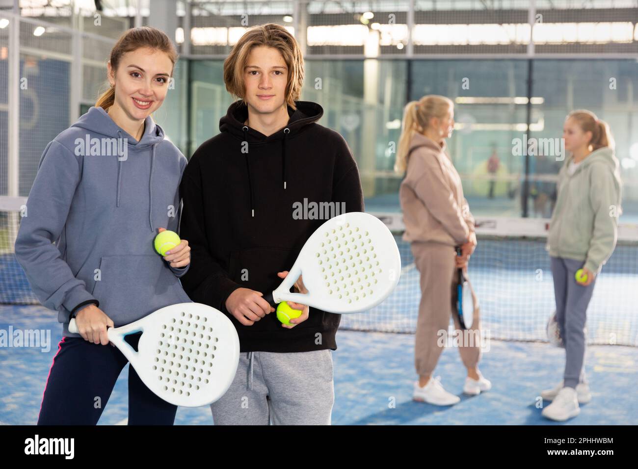 Teenage boy and young woman in padel court Stock Photo - Alamy