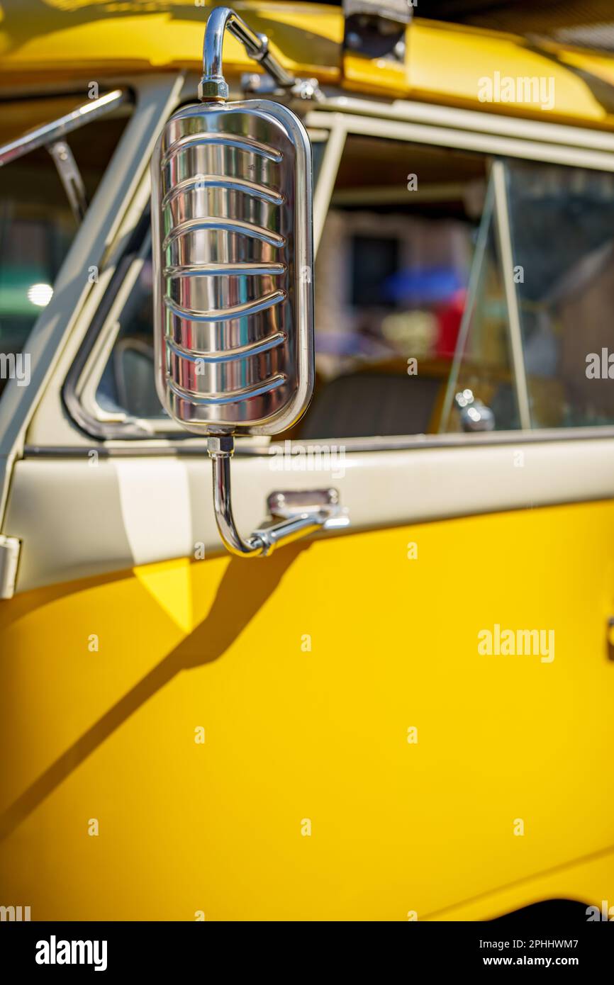 Image of a yellow tour bus with chrome rear view mirror Stock Photo - Alamy