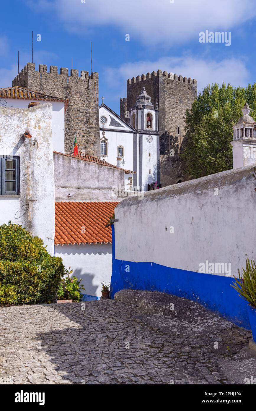 Europe, Portugal, Obidos. Castle wall behind homes in Obidos Stock ...