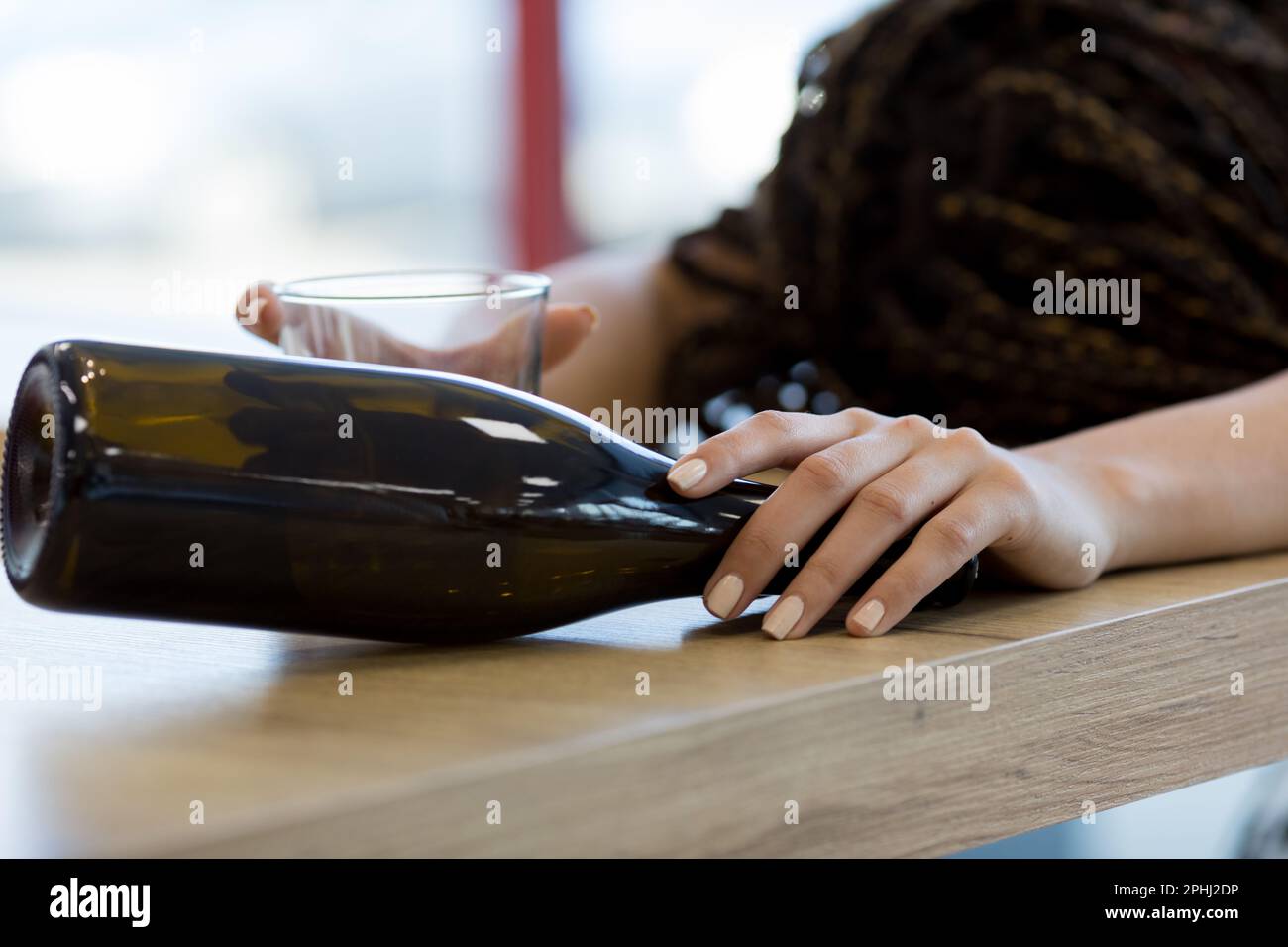 A woman or girl slumps face-down on her beautiful kitchen table with an ...