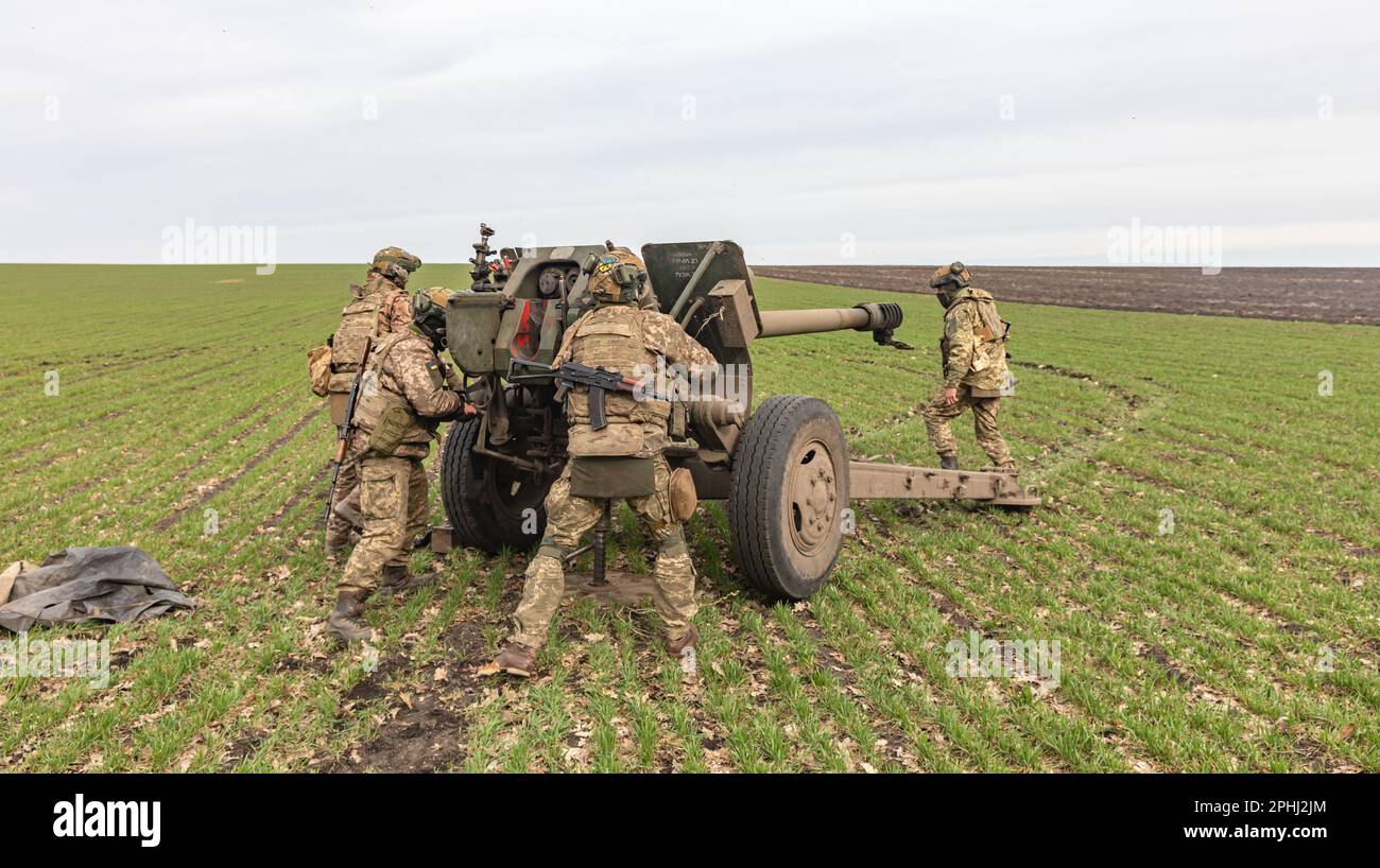 A Ukrainian soldier is seen preparing to fire the 122 mm D-30 howitzer ...