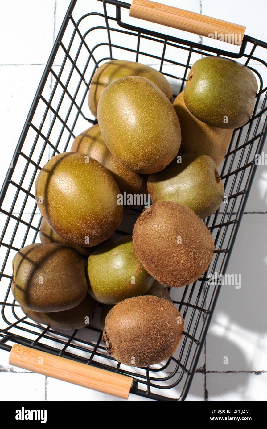 A basket of ripe kiwis of various types. Green, gold and red kiwi Stock ...