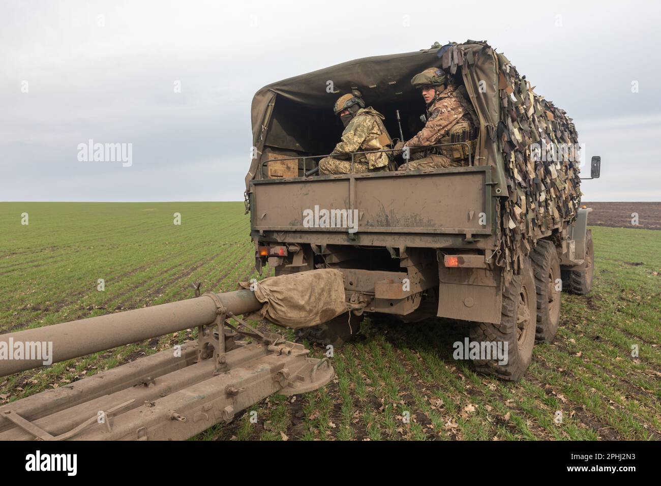 The artillery crew leaves the firing position and moves to a new firing ...