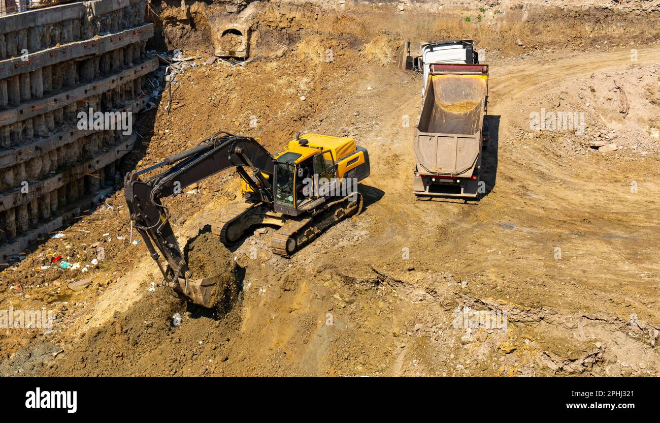 Excavator and truck working in construction, loading on truck Stock ...