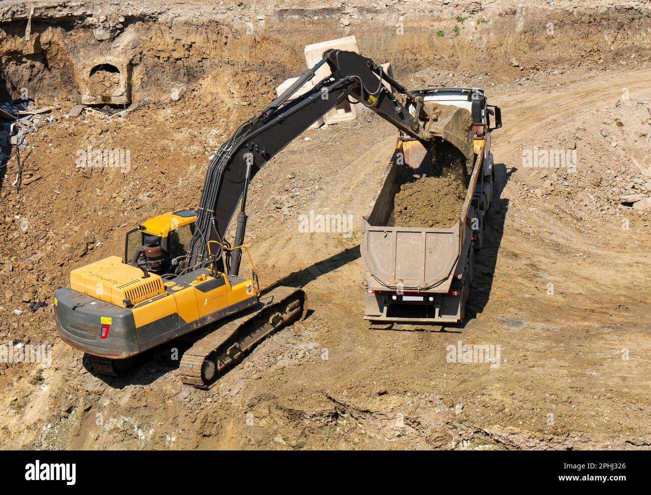 Excavator and truck working in construction, loading on truck Stock ...