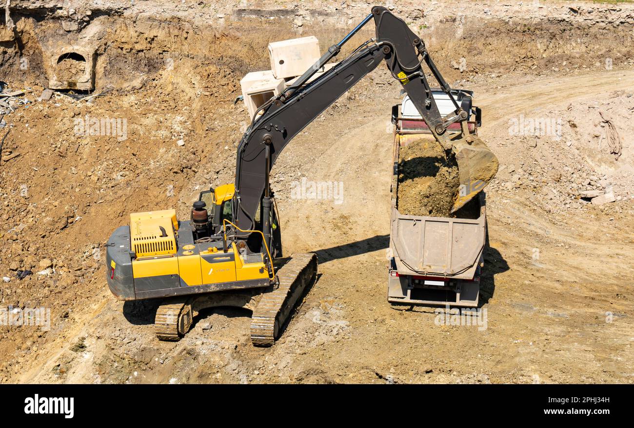 Excavator and truck working in construction, loading on truck Stock ...