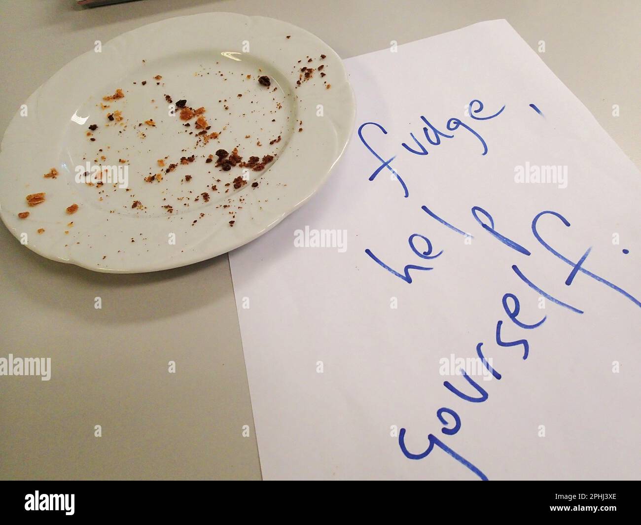 Empty plate with crumbs, beside handwritten sign saying what was on the ...