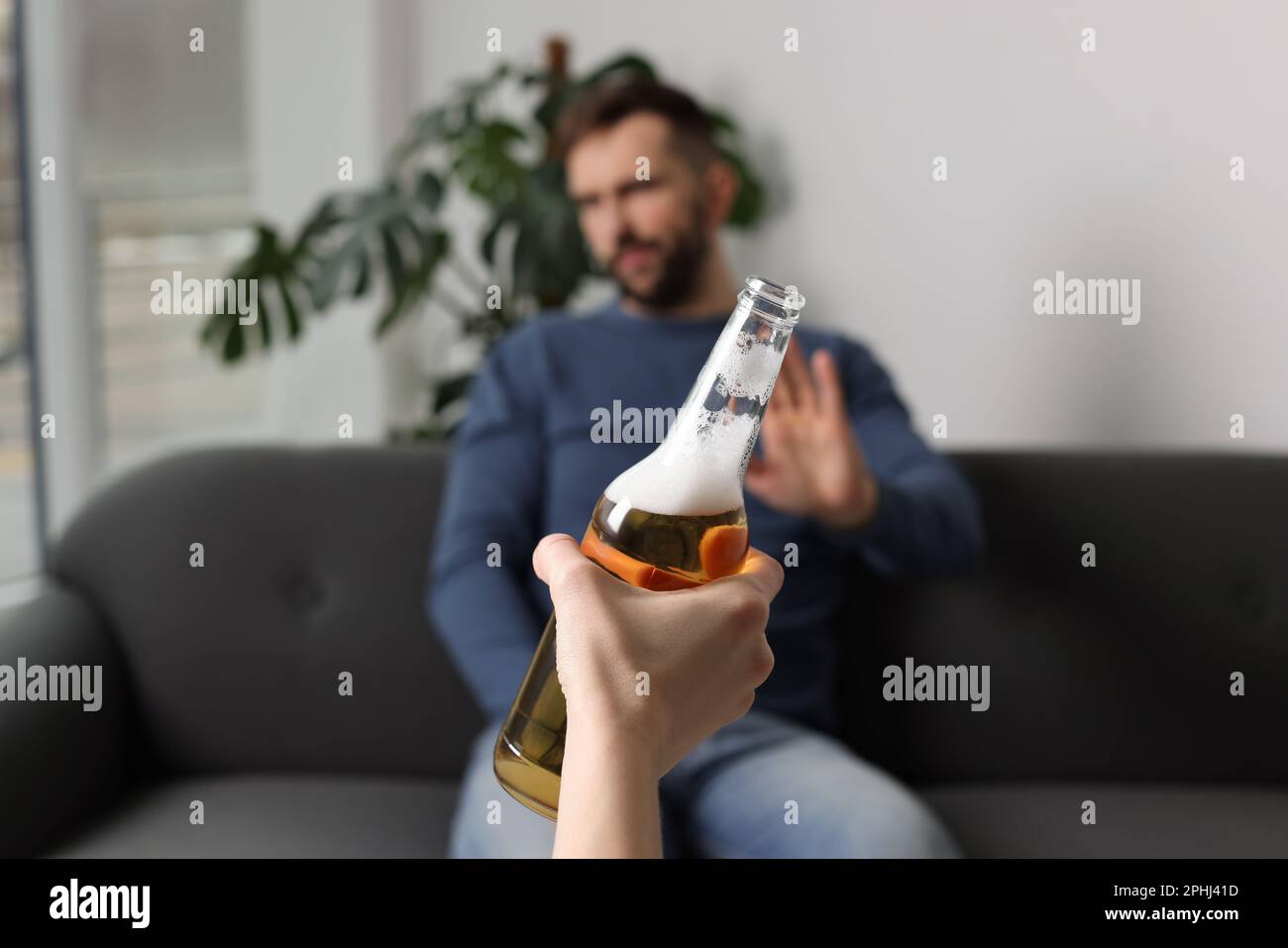 Man refusing to drink beer indoors, closeup. Alcohol addiction ...