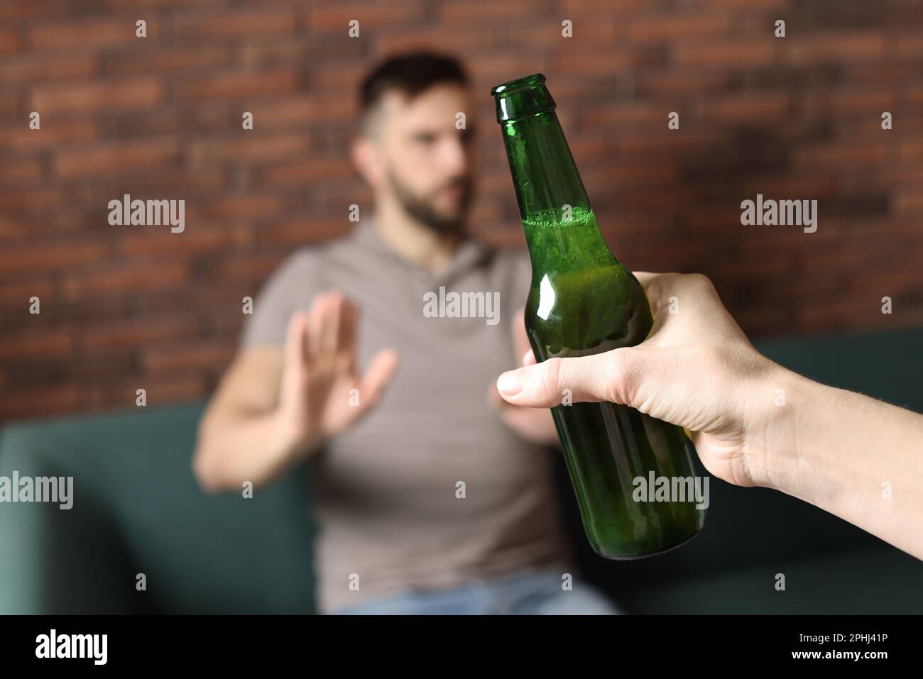 Man refusing to drink beer indoors, closeup. Alcohol addiction ...