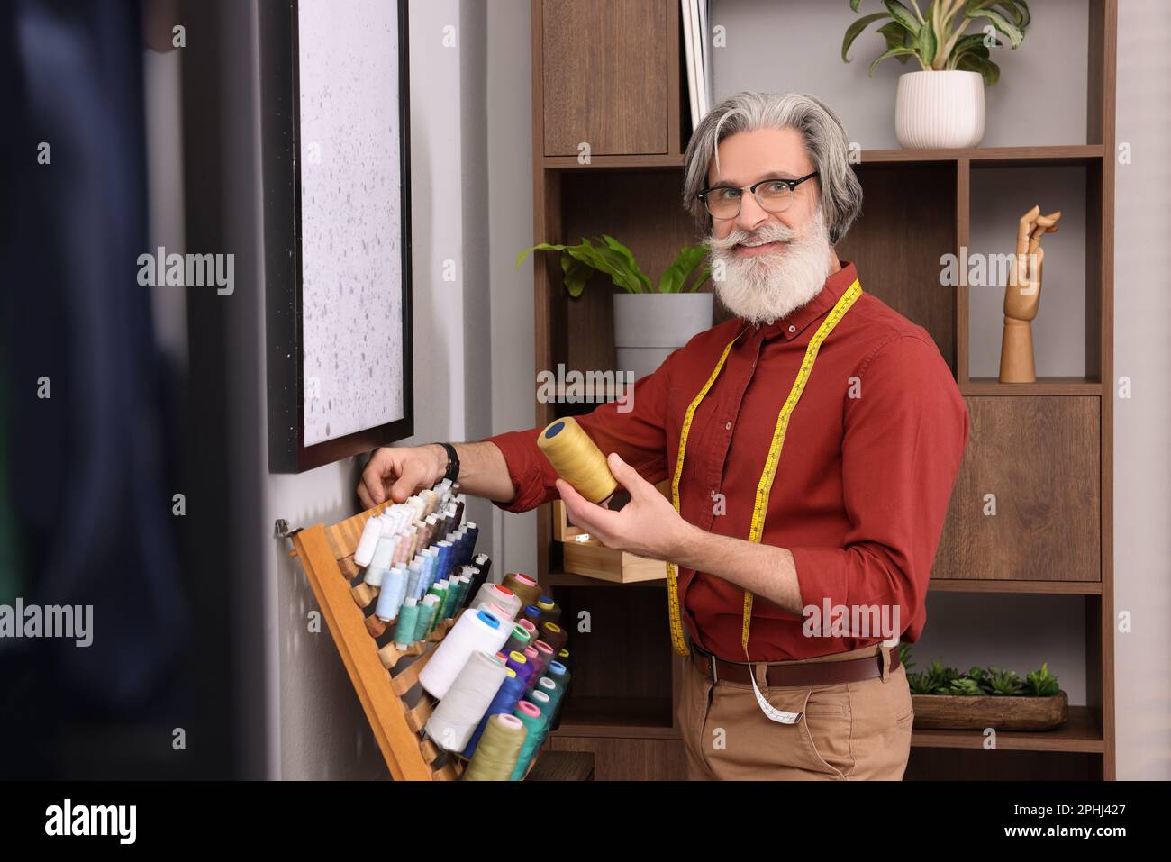 Professional tailor choosing thread hi-res stock photography and images ...