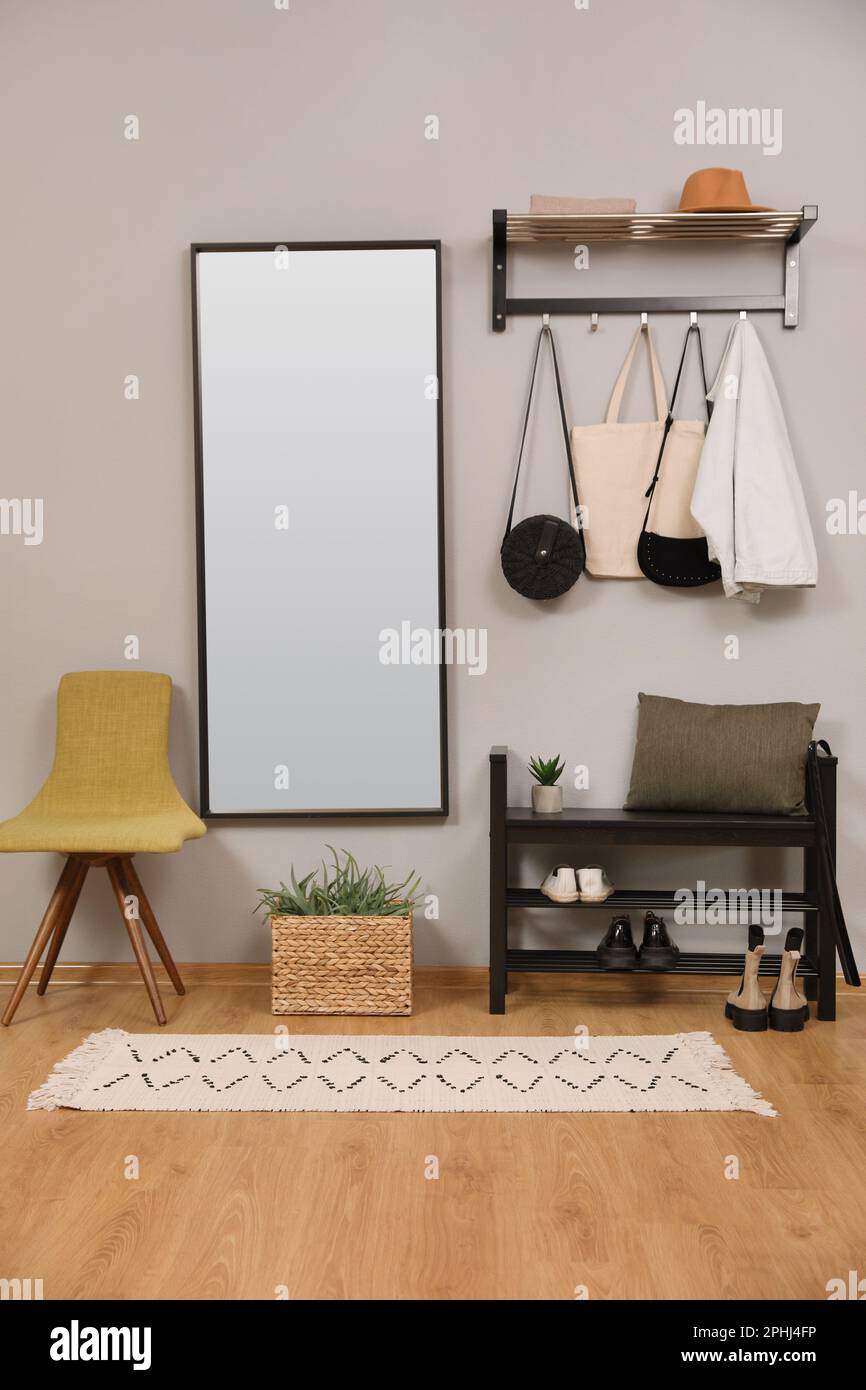 Modern hallway interior with stylish chair, shoe rack and mirror Stock ...