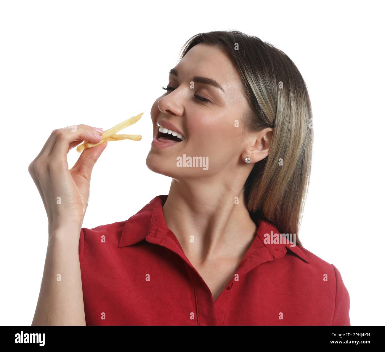 Young woman eating French fries on white background Stock Photo - Alamy