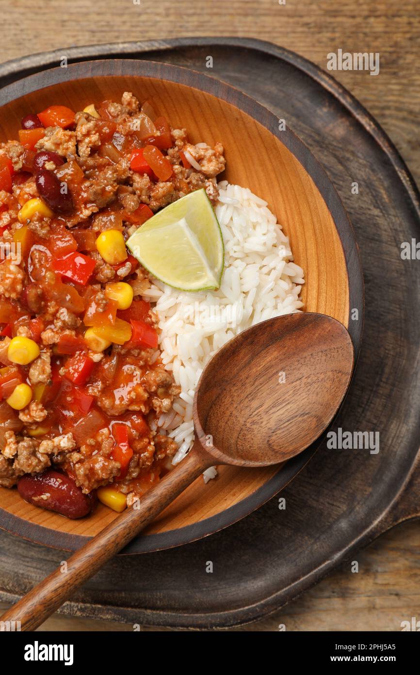 Plate of rice with chili con carne on wooden table, top view Stock ...