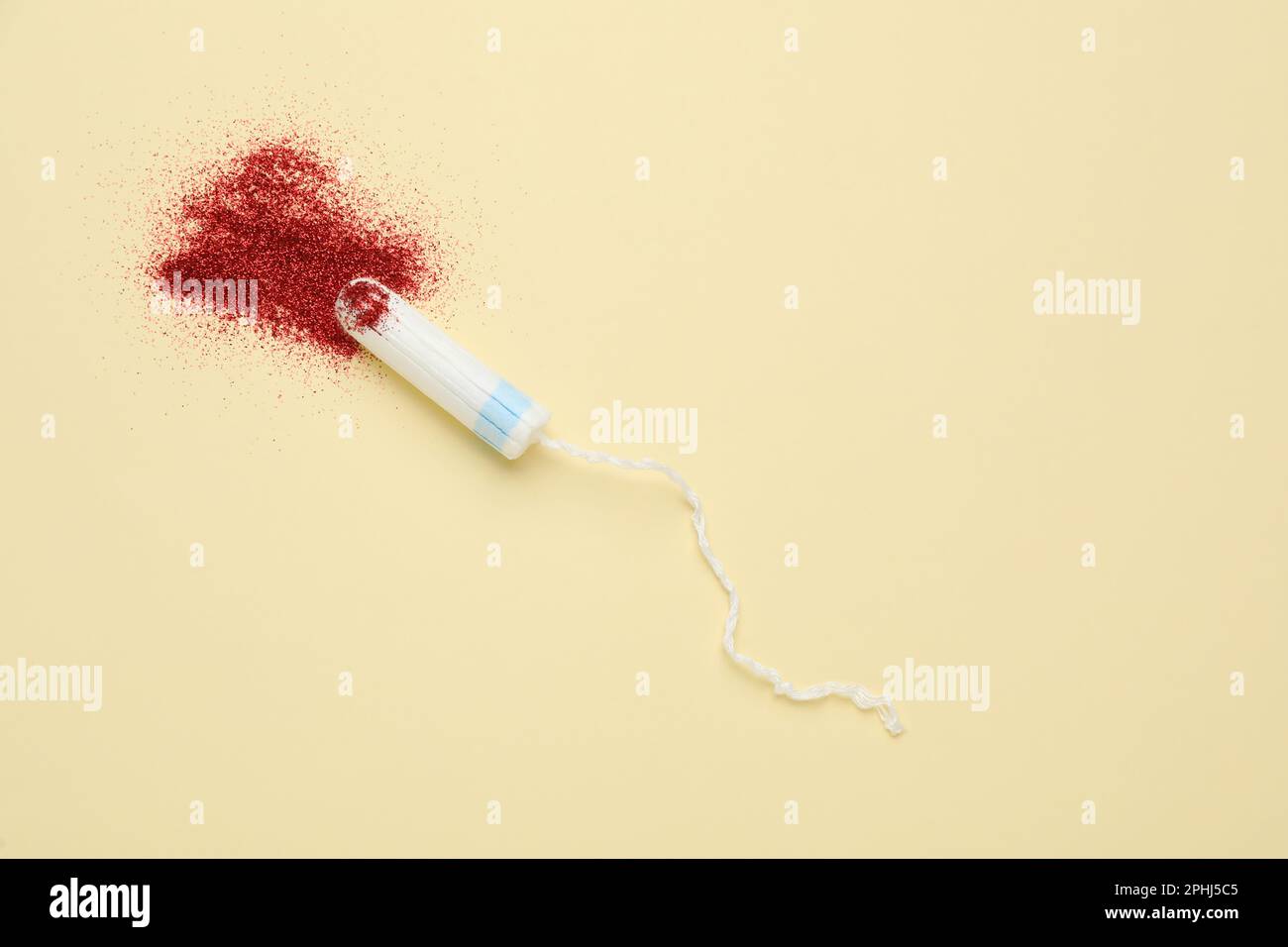 Tampon with red glitter on beige background, flat lay and space for ...