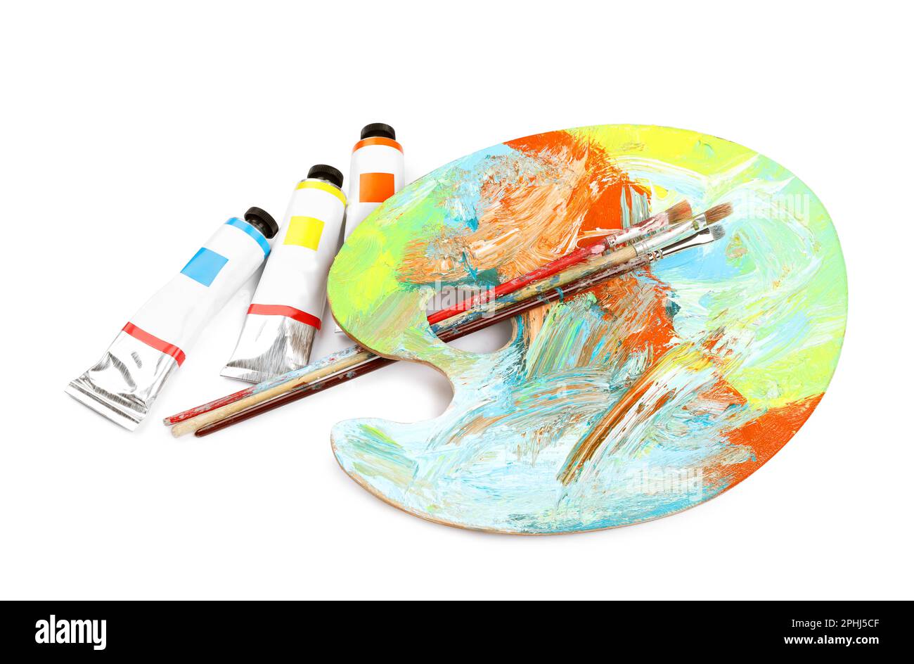Dirty artist's palette with brushes and tubes of paint on white ...