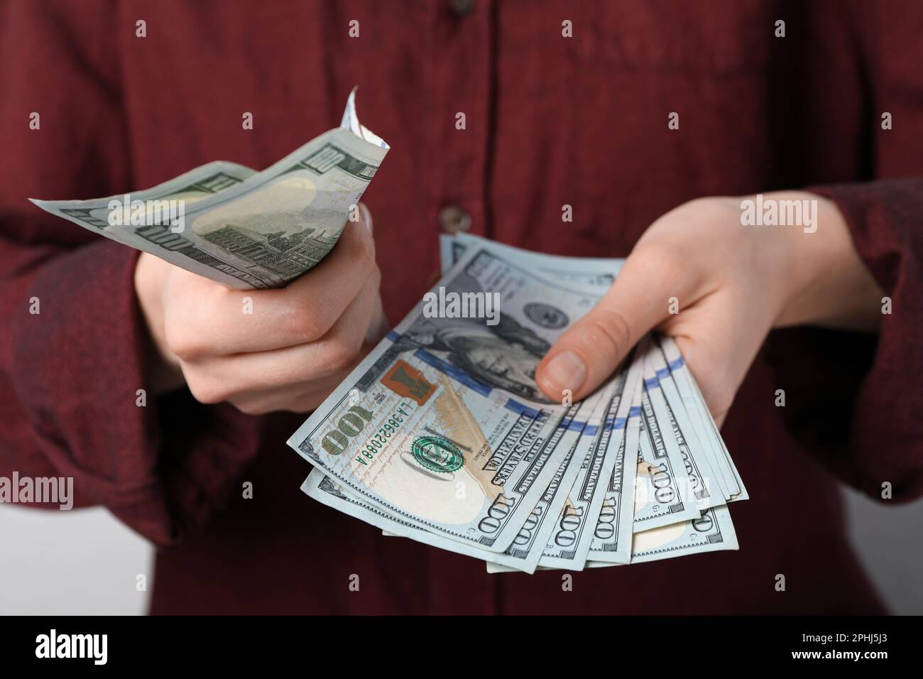 Woman counting dollar banknotes on light background, closeup Stock ...