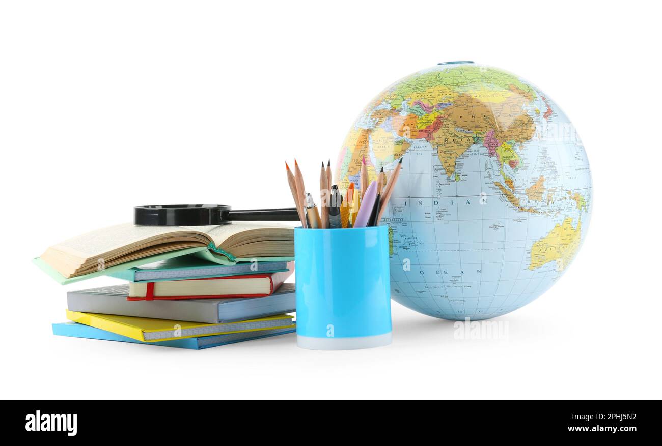 Plastic model globe of Earth, colorful pencils, magnifying glass and ...