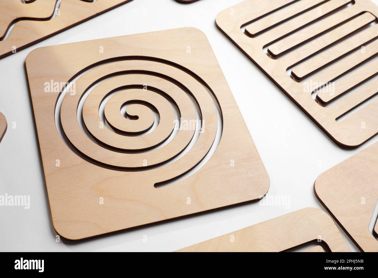 Wooden finger labyrinths on white background. Montessori toy Stock ...