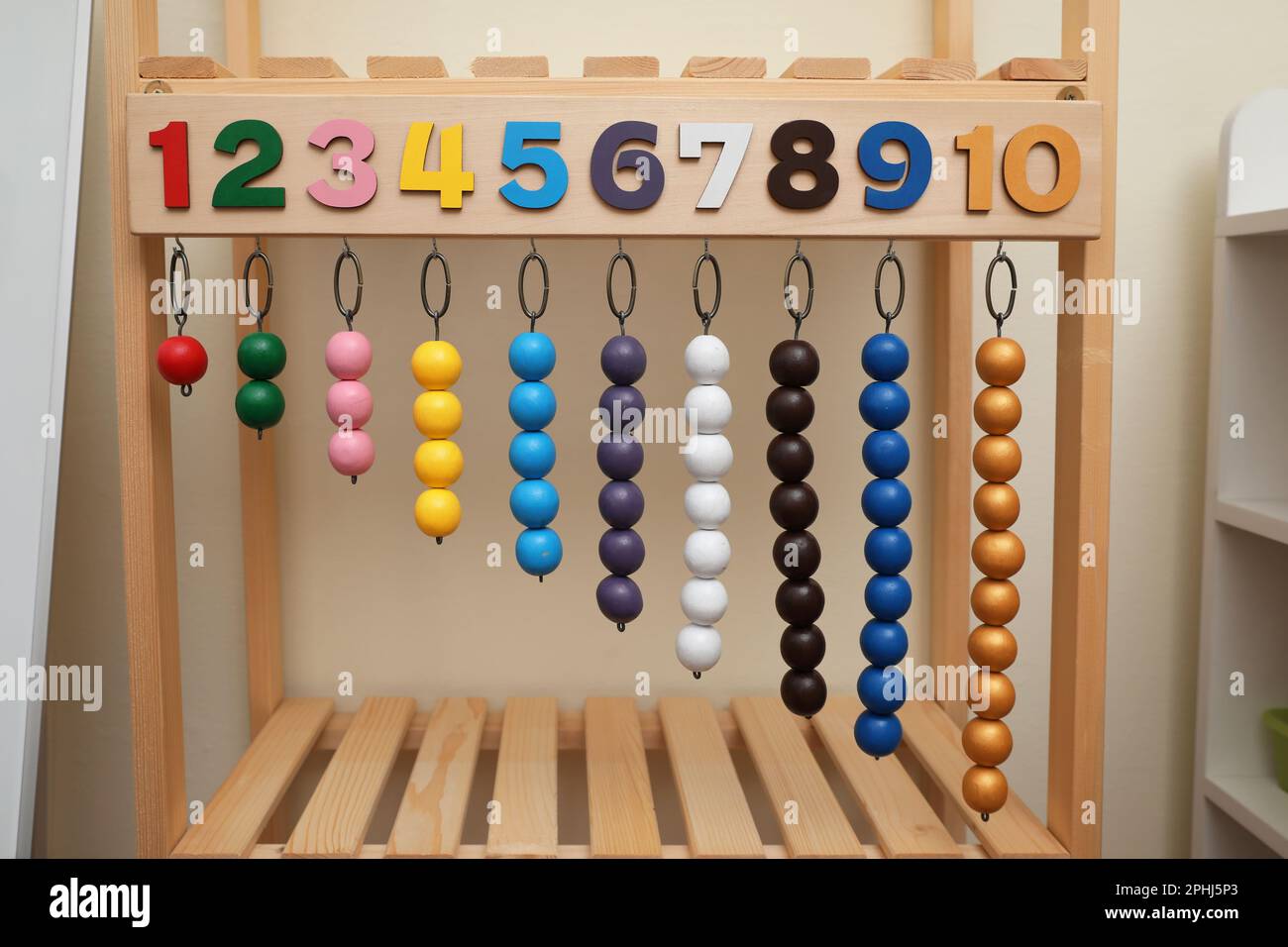Montessori toy with color bead lines and numbers on wooden stand ...