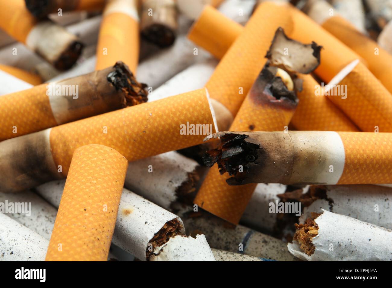 Pile of cigarette stubs as background, closeup view Stock Photo - Alamy