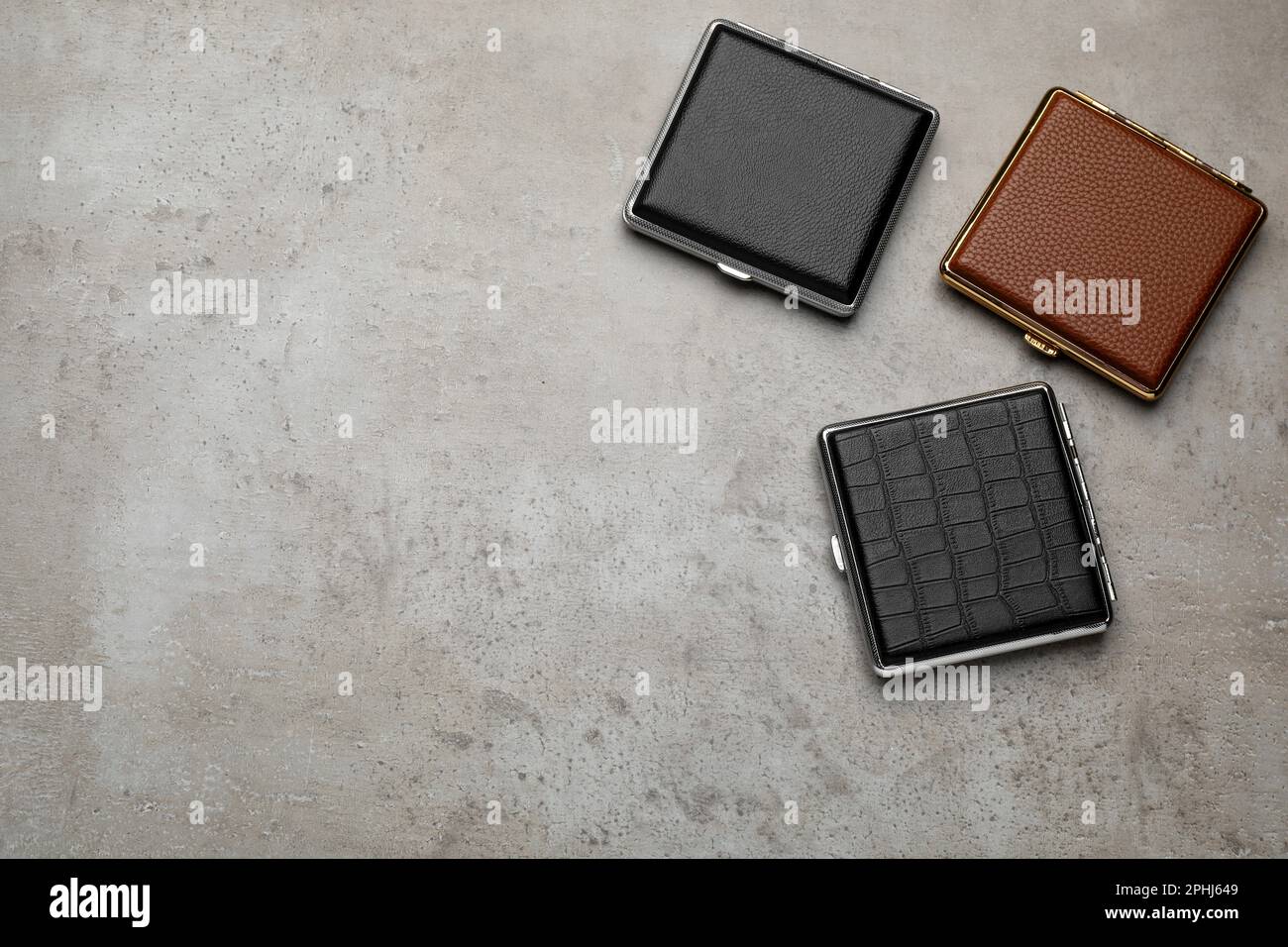 Closed cigarette cases on grey table, flat lay. Space for text Stock ...