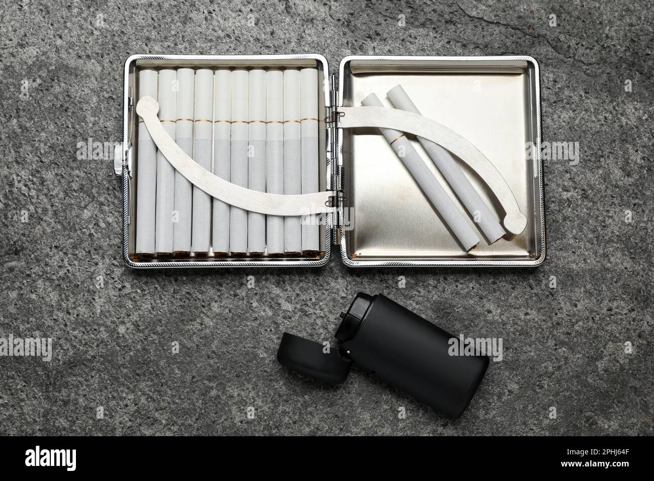 Open case with tobacco filter cigarettes and lighter on grey table ... Open case with tobacco filter cigarettes and lighter on grey table ...