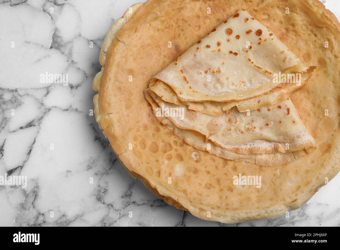 Delicious crepes on white marble table, top view Stock Photo - Alamy