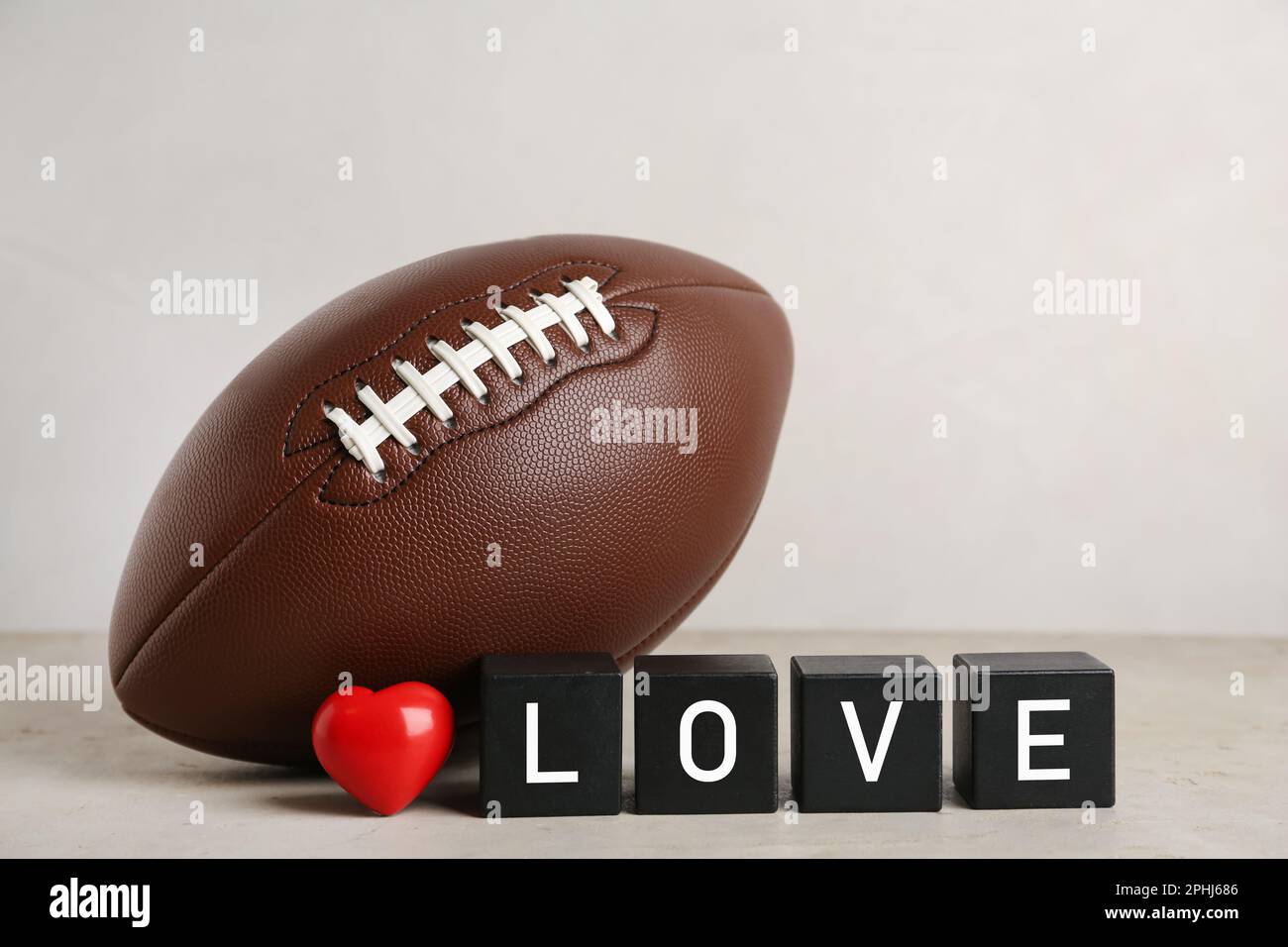American football ball, cubes with word Love and heart on light grey ...