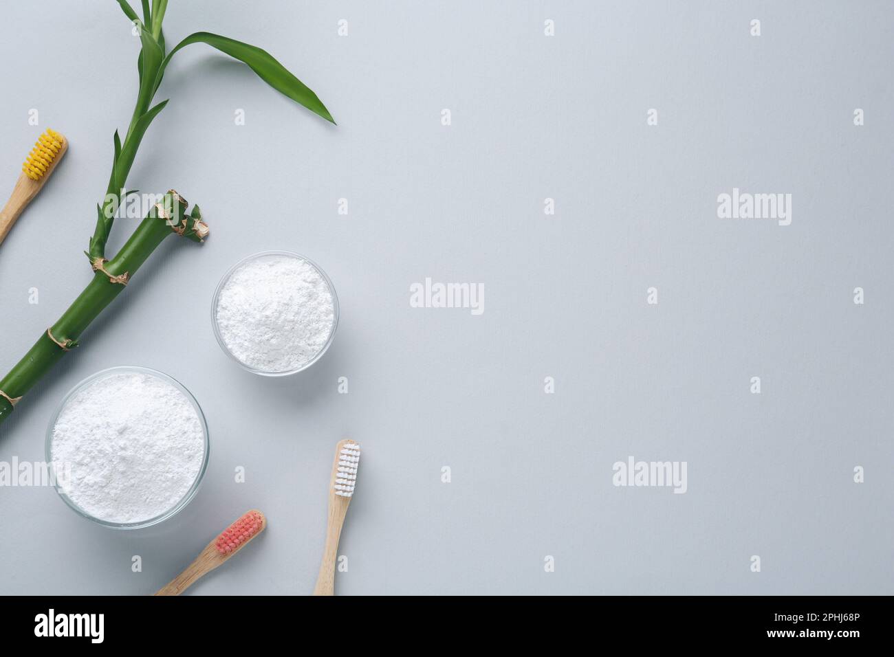 Tooth powder, brushes and bamboo stem on white background, flat lay ...