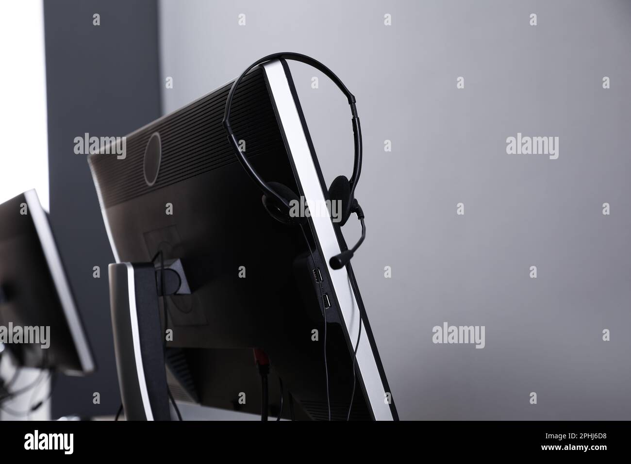 Modern computer with headset in office. Hotline service Stock Photo - Alamy
