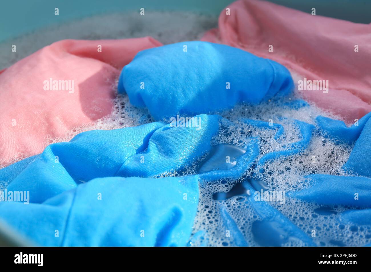 Colorful clothes in suds, closeup. Hand washing laundry Stock Photo - Alamy