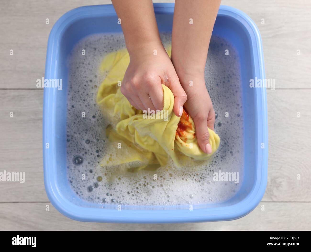 Woman washing garment with stain, top view Stock Photo - Alamy
