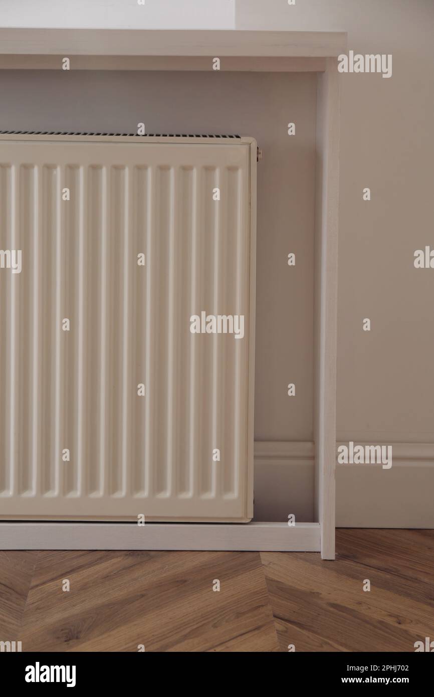 Modern panel radiator on white wall indoors Stock Photo - Alamy