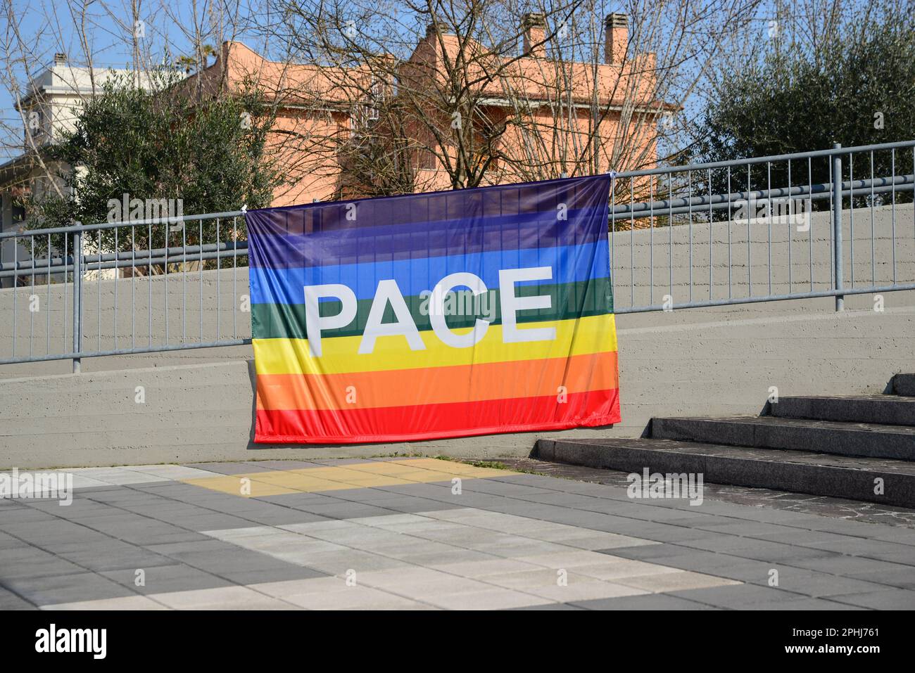 Beautiful rainbow peace flag with word PACE hanging on metal railing ...