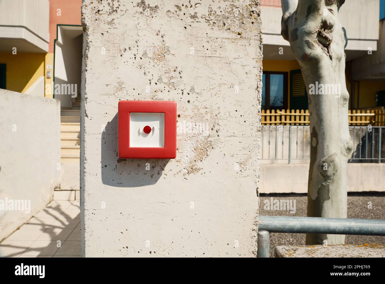 Red emergency button on stone pillar outdoors Stock Photo - Alamy