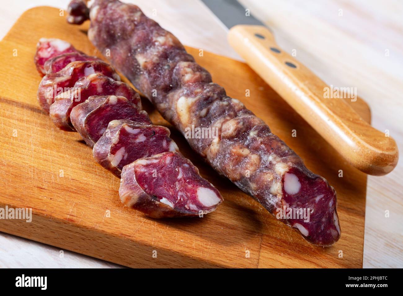 Sliced french dry sausage Stock Photo - Alamy