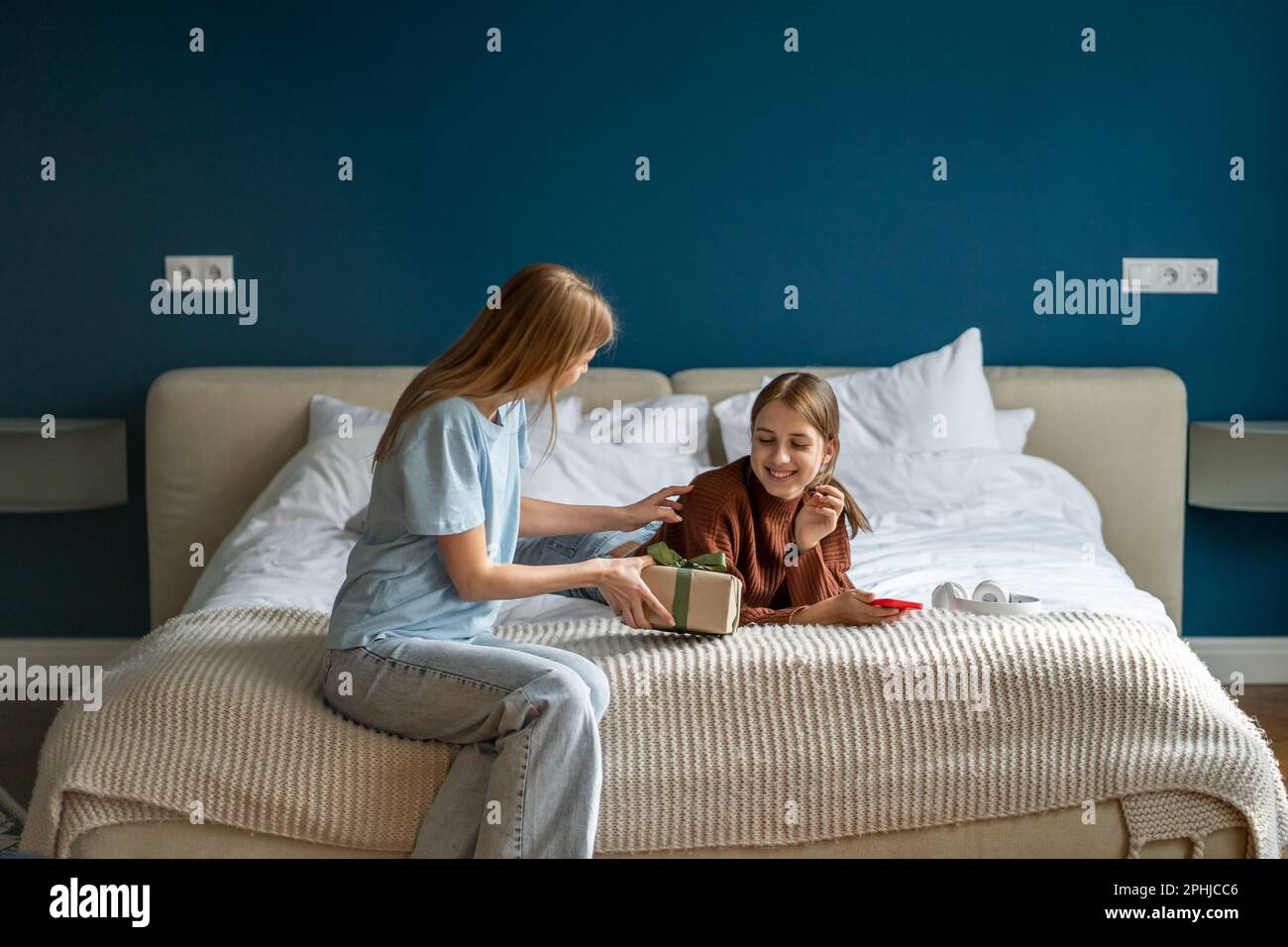Happy surprised adolescent teen girl receiving birthday present from ...
