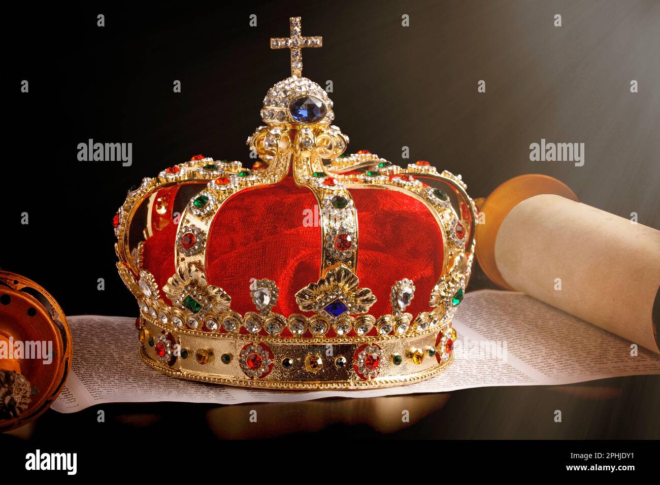 A Gold Coronation Crown with Red Velevet on a Bible on an Open Scroll ...