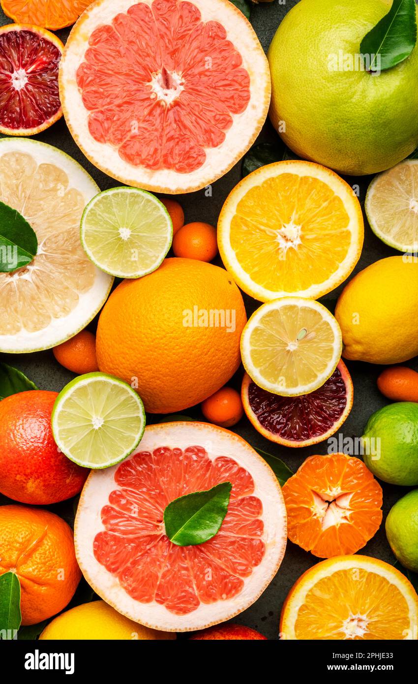 Citrus fruit food background, top view. Mix of different whole and ...